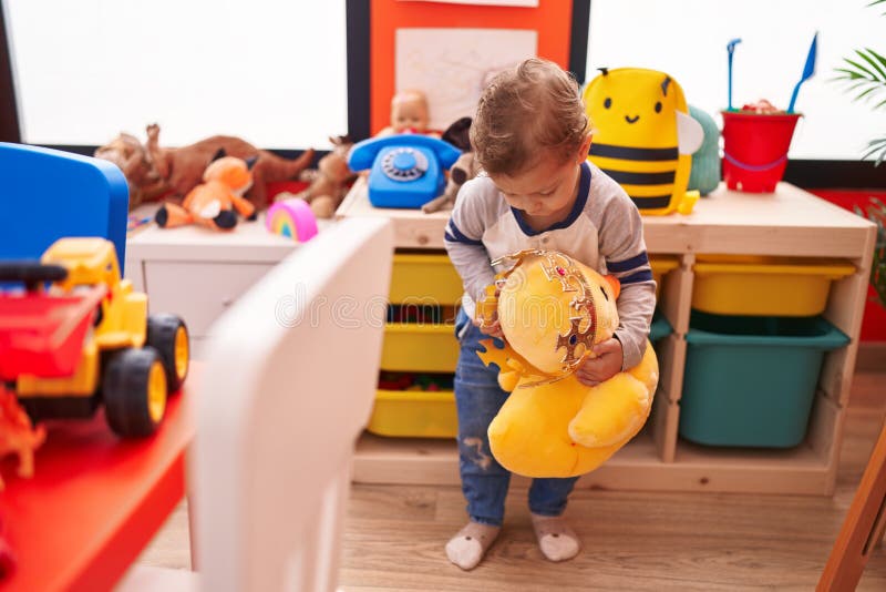 Adorable Caucasian Boy Playing with Duck Doll at Kindergarten Stock ...