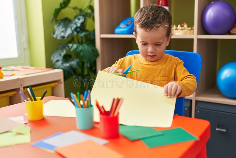 Adorable Caucasian Boy Student Cutting Paper Sitting on Table at ...