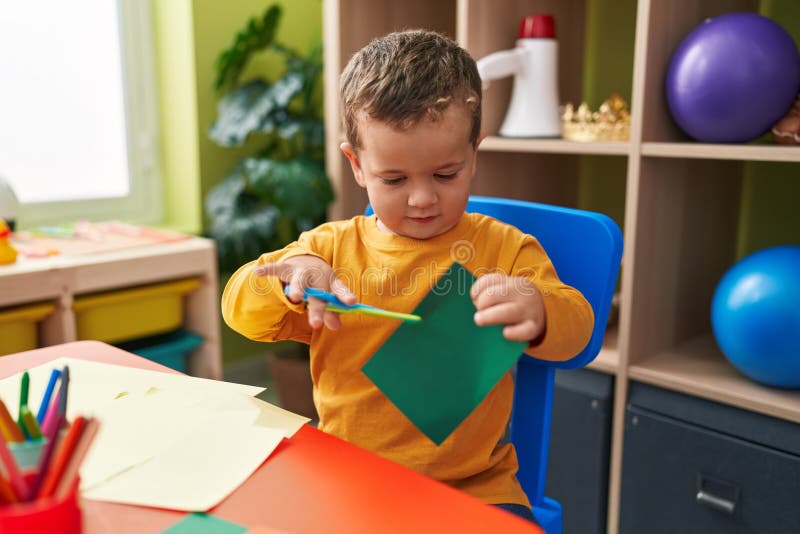 Adorable Caucasian Boy Student Cutting Paper Sitting on Table at ...