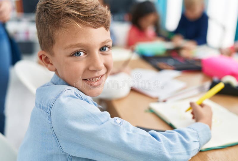 Adorable Caucasian Boy Student Drawing on Notebook Studying at ...