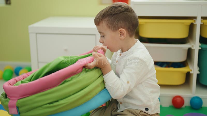 Adorable Caucasian Boy Student Sitting on Floor with Relaxed Expression ...