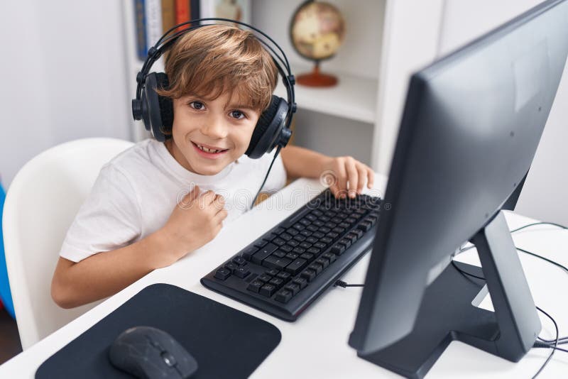 Adorable Caucasian Boy Student Using Computer Sitting on Table at ...