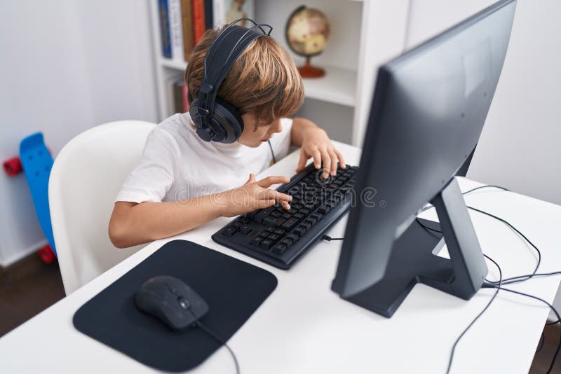 Adorable Caucasian Boy Student Using Computer Sitting on Table at ...