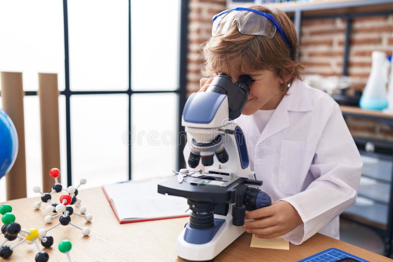 Adorable Caucasian Boy Student Using Microscope at Classroom Stock ...