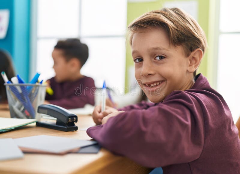 Adorable Caucasian Boy Student Writing on Notebook Studying at ...