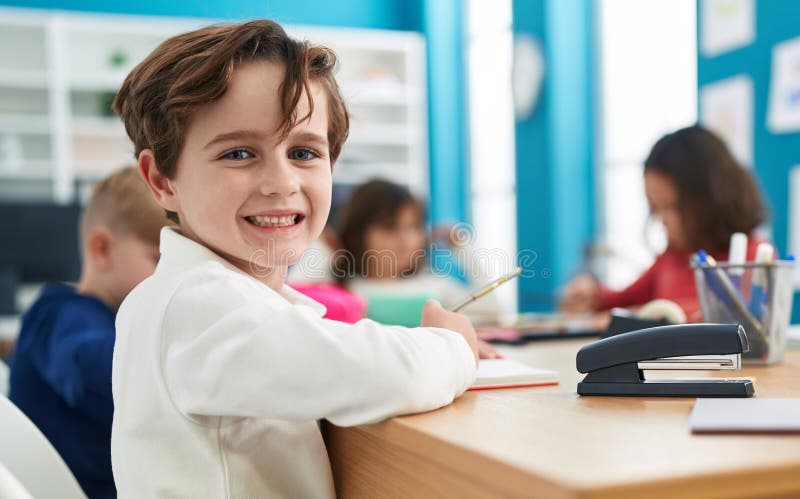 Adorable Caucasian Boy Student Writing on Notebook Studying at ...
