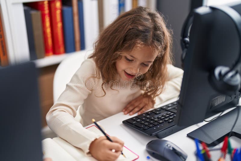 Adorable Caucasian Girl Student Using Computer Writing on Notebook at ...