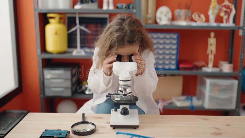 Adorable Caucasian Girl Student Using Microscope at Classroom Stock ...