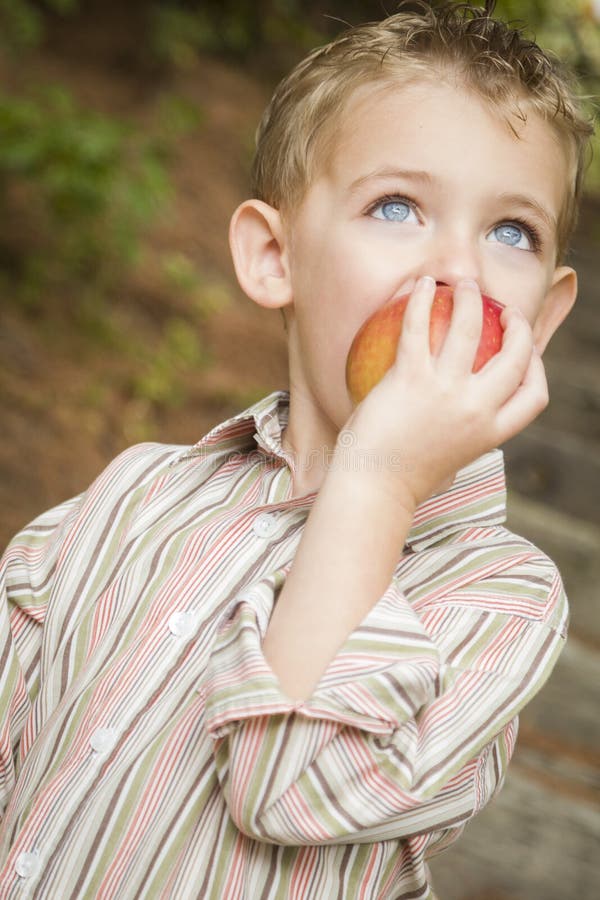Adorable Child Boy Eating Red Apple Outside Stock Photo - Image of ...