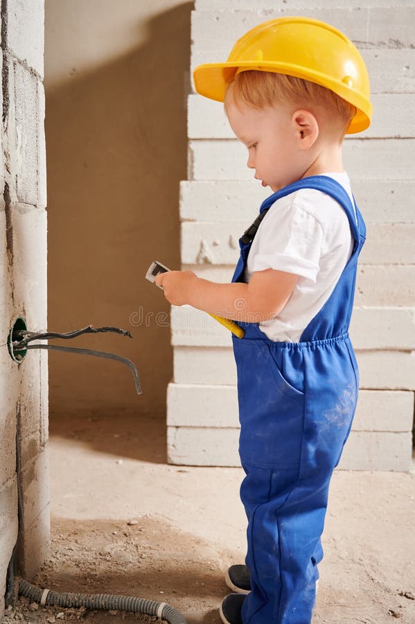 Little Boy Cutting Electric Wire at Home during Renovation. Stock Photo ...