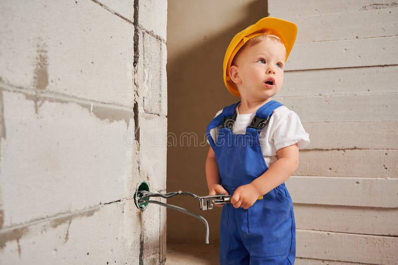 Little Boy Cutting Electric Wire at Home during Renovation. Stock Photo ...