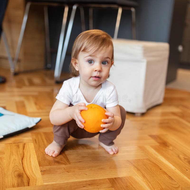 Adorable One Year Baby Girl Playing with Orange Stock Image - Image of ...