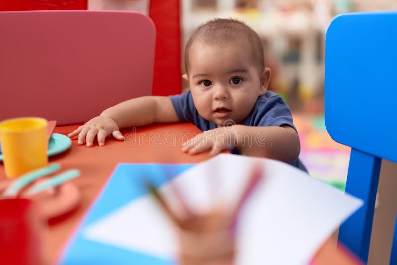 Adorable Chinese Toddler Leaning on Table Standing at Kindergarten ...