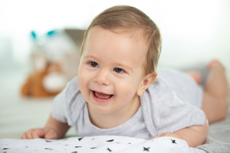 Adorable Contented Baby Lying on Bed Stock Image - Image of babygrow ...