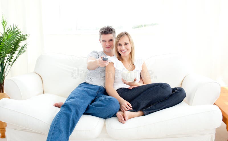 Adorable Couple Using a Remote in the Living-room Stock Photo - Image ...
