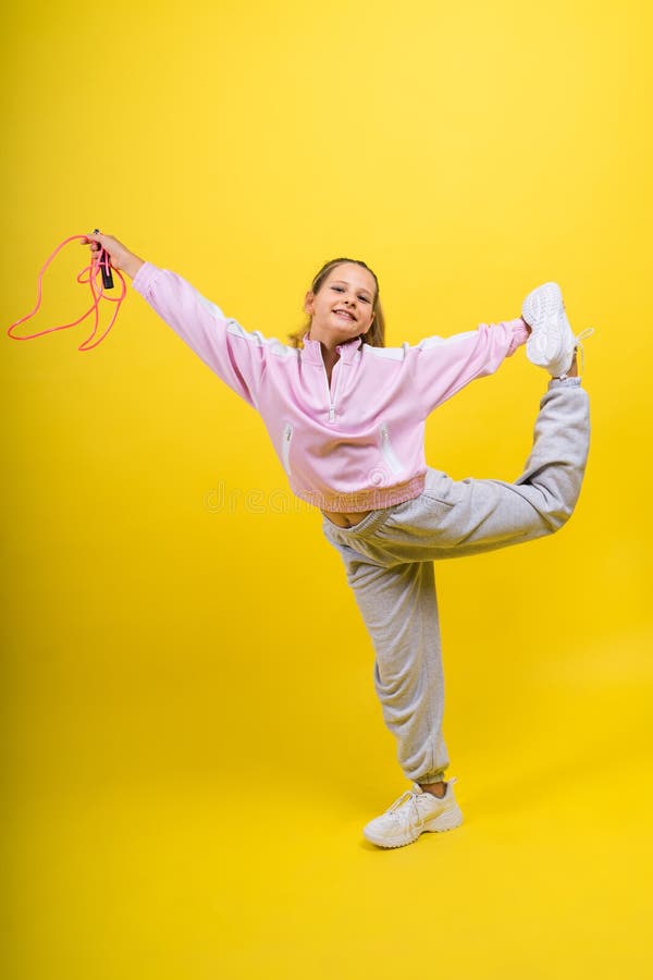 Adorable Female Child with Skipping Rope Jumping in Studio Stock Photo ...