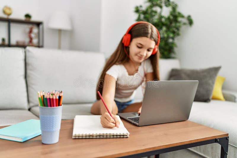 Adorable Girl Doing Homework Using Laptop at Home Stock Photo - Image ...