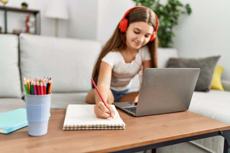 Adorable Girl Doing Homework Using Laptop at Home Stock Photo - Image ...