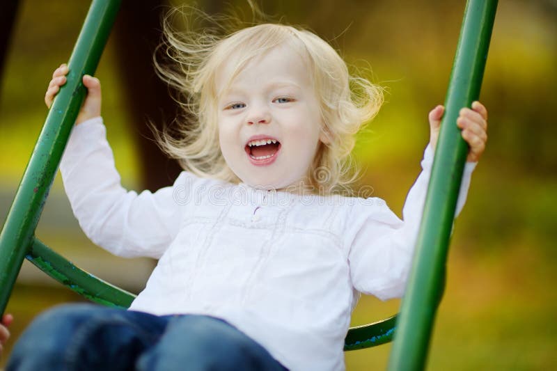 Adorable Girl Having Fun on a Swing Stock Photo - Image of enjoyment ...