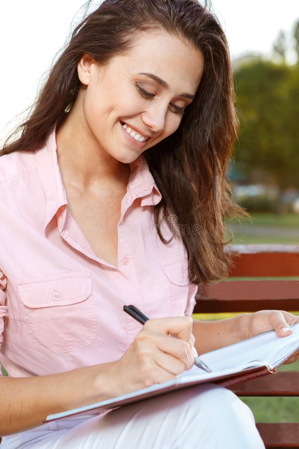 Adorable girl making notes stock image. Image of outdoor - 63199677