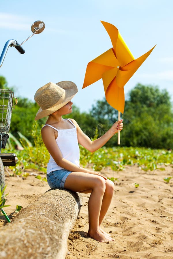 Adorable Girl Playing with Paper Windmill Stock Image - Image of sand ...
