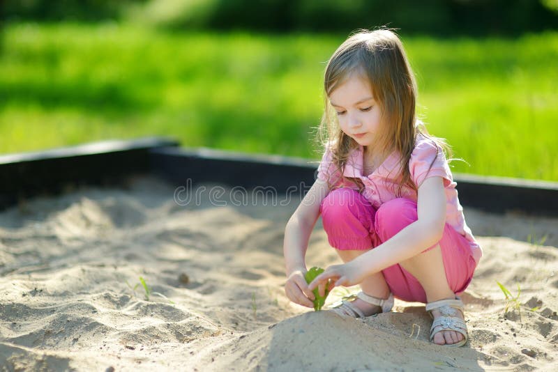 Adorable Girl Playing in a Sandbox Stock Photo - Image of daughter ...
