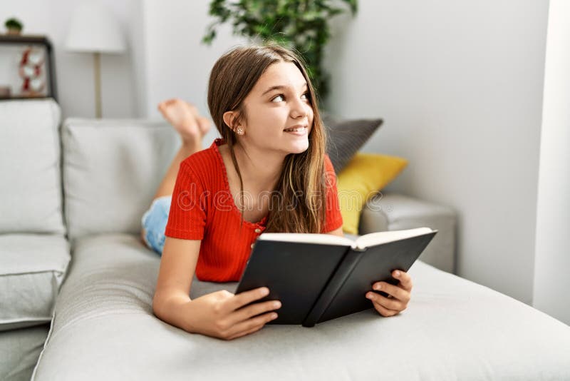 Adorable Girl Smiling Confident Reading Book at Home Stock Photo ...