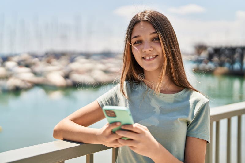 Adorable Girl Smiling Confident Using Smartphone at Seaside Stock Photo ...