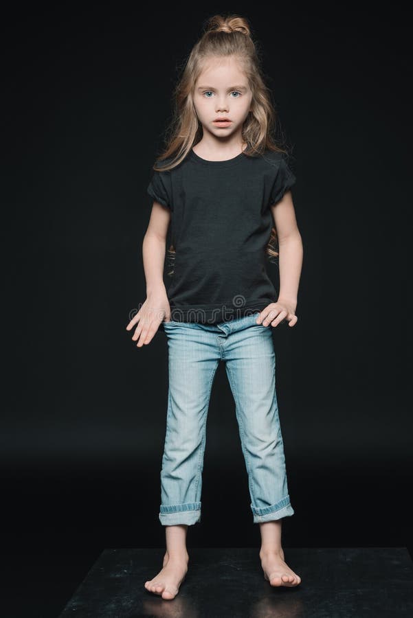 Adorable Girl Standing and Looking at Camera, on Black Stock Image ...