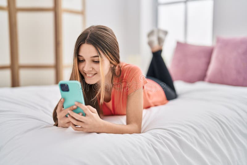 Adorable Girl Using Smartphone Lying on Bed at Bedroom Stock Image ...