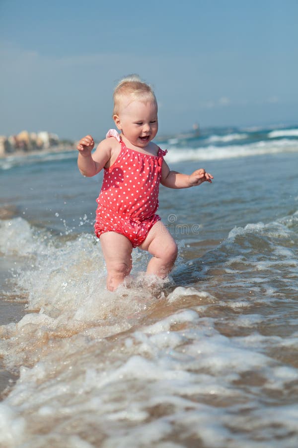 Adorable Girl Walking Along Beach Stock Photo - Image of toddler, spain ...