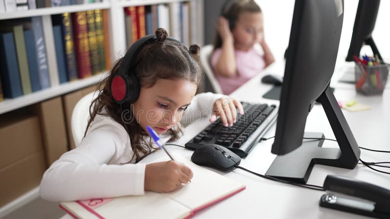 Adorable Girls Student Using Computer Writing Notes at Classroom Stock ...