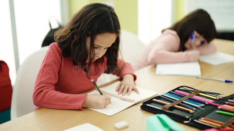Adorable Girls Students Sitting on Table Drawing on Notebook at ...