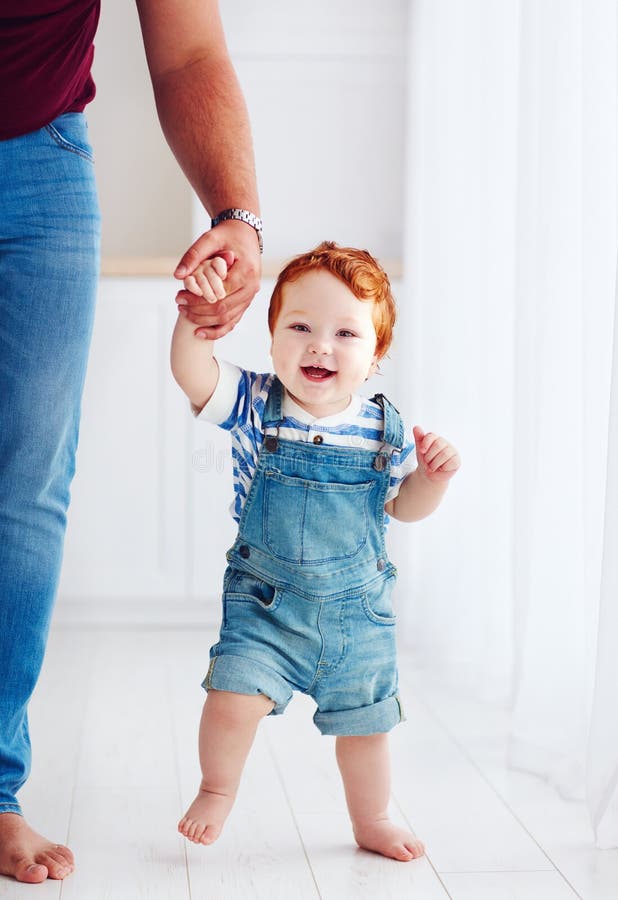 Adorable Happy Toddler Boy Walking with the Help of the Father Stock ...