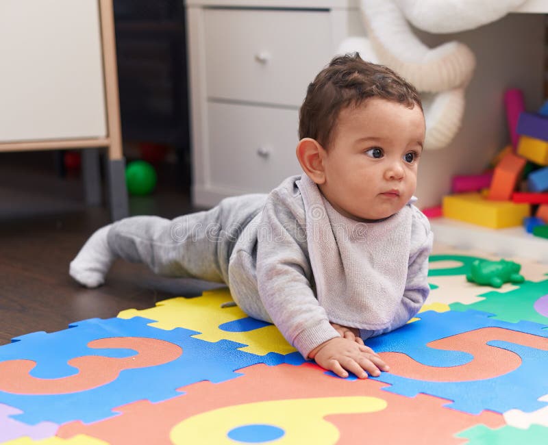 Adorable Hispanic Baby Crawling on Floor at Kindergarten Stock Image ...