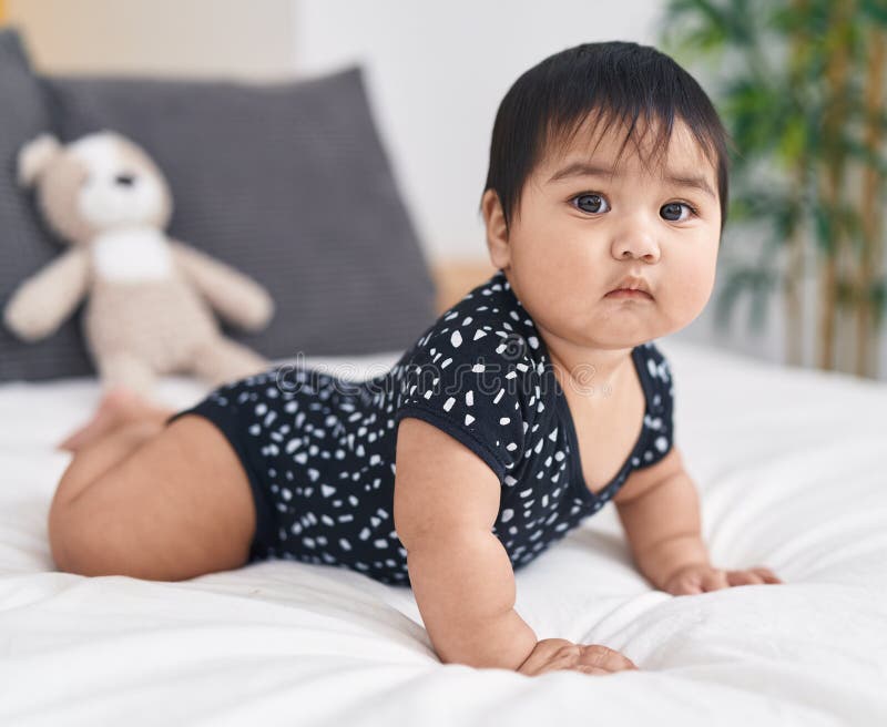 Adorable Hispanic Baby Lying on Bed at Bedroom Stock Photo - Image of ...
