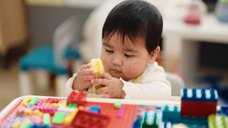 Adorable Hispanic Baby Playing with Construction Blocks Sitting on ...