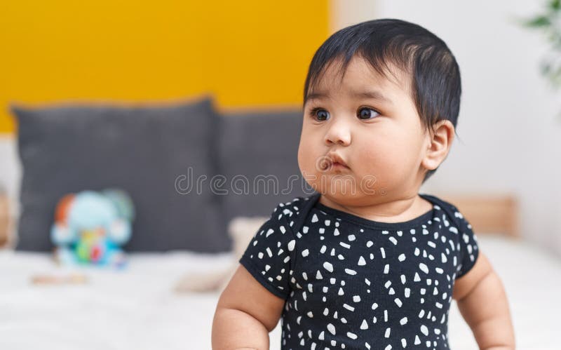 Adorable Hispanic Baby Sitting on Bed at Bedroom Stock Photo - Image of ...