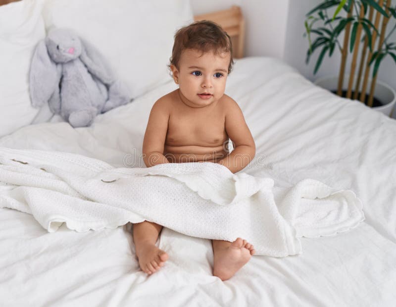 Adorable Hispanic Baby Sitting on Bed at Bedroom Stock Image - Image of ...