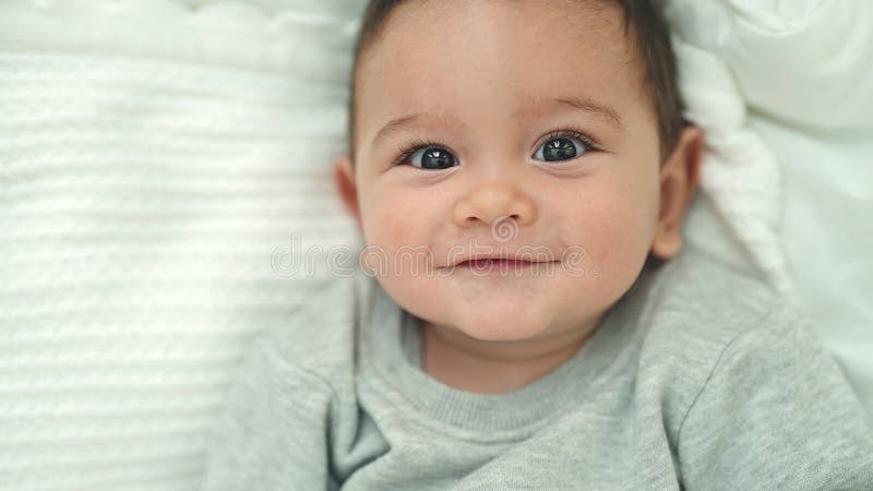 Adorable Hispanic Baby Smiling Confident Lying on Bed at Bedroom Stock ...