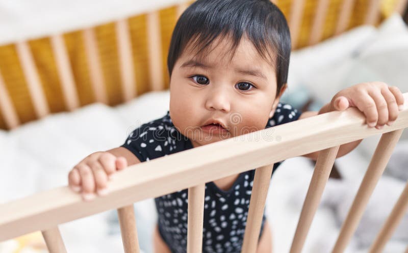 Adorable Hispanic Baby Standing on Cradle at Bedroom Stock Image ...