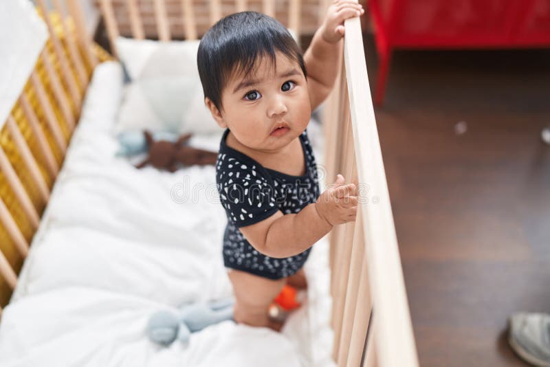 Adorable Hispanic Baby Standing on Cradle at Bedroom Stock Image ...