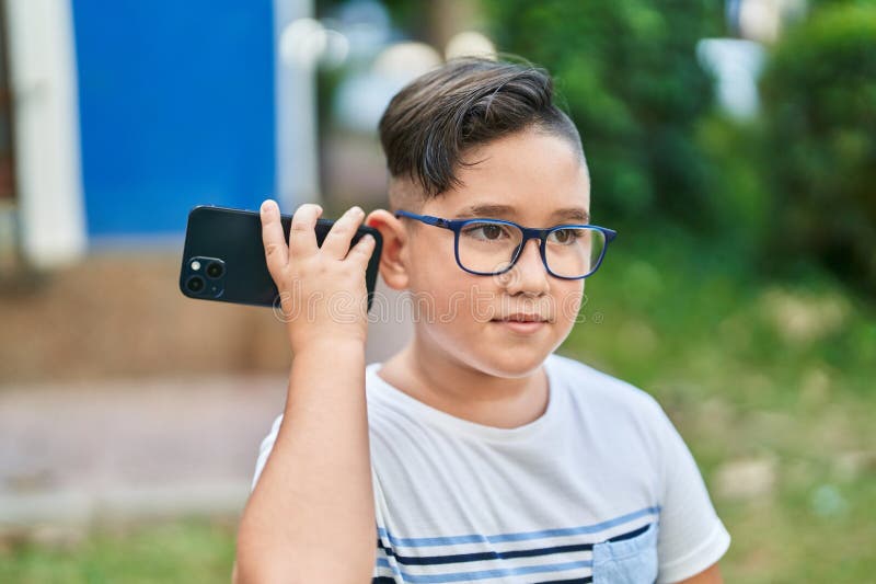 Adorable Hispanic Boy Listening Voice Message by Smartphone with ...