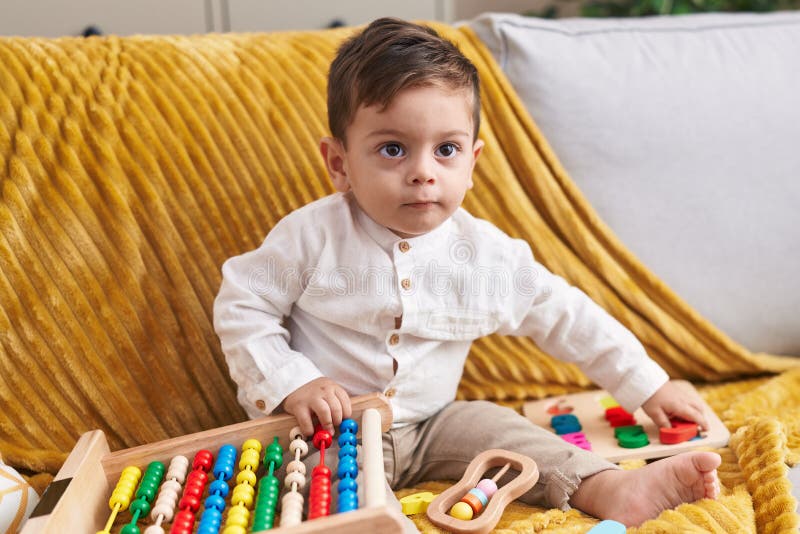 Adorable Hispanic Boy Playing with Abacus Sitting on Sofa at Home Stock ...