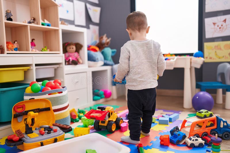 Adorable Hispanic Boy Playing with Car Toy Standing at Kindergarten ...