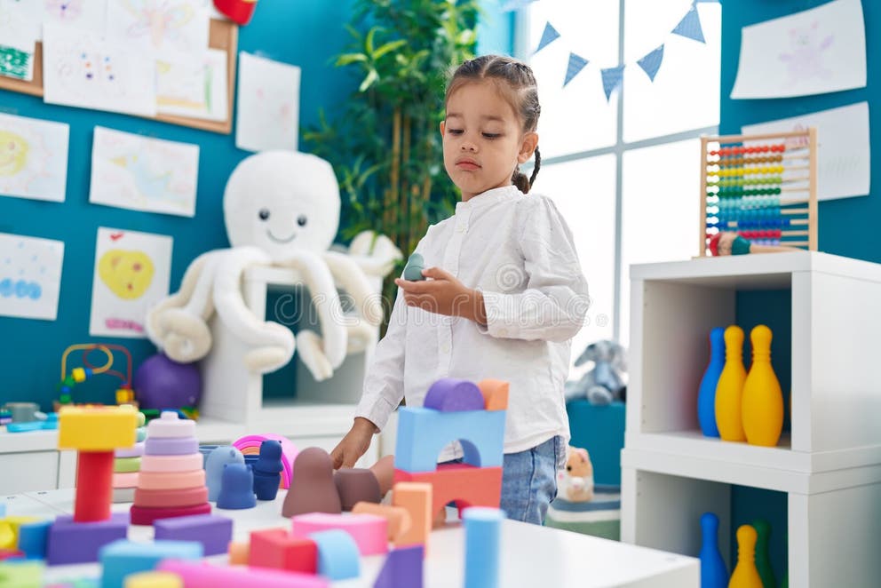 Adorable Hispanic Boy Playing with Construction Blocks Standing at ...