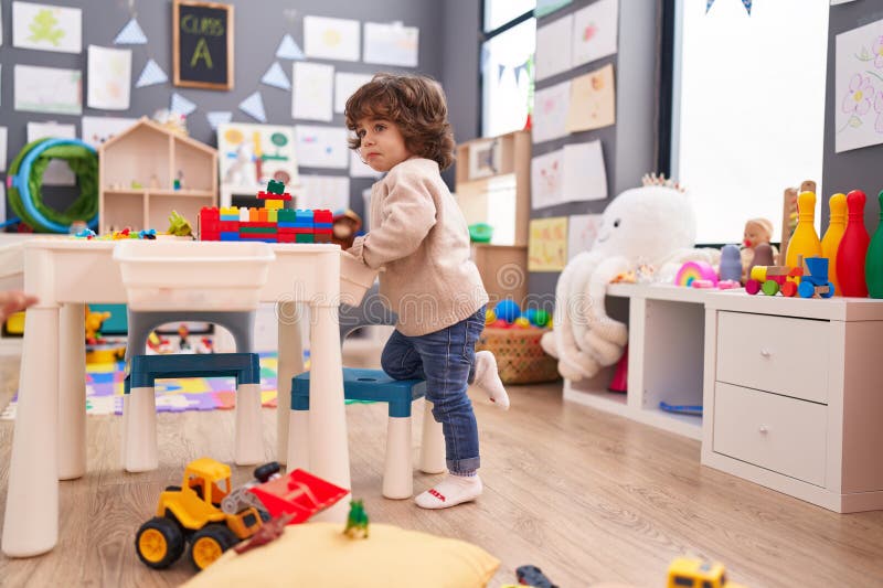 Adorable Hispanic Boy Playing with Construction Blocks Standing at ...