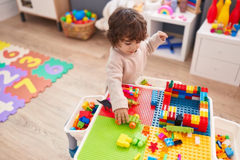 Adorable Hispanic Boy Playing with Construction Blocks Standing at ...