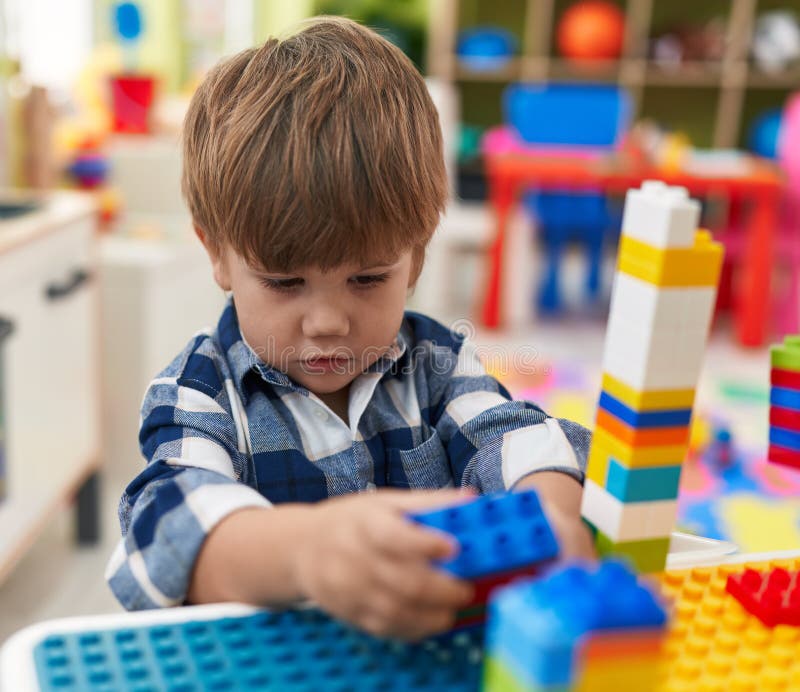 Adorable Hispanic Boy Playing with Construction Blocks Standing at ...