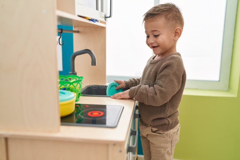 Adorable Hispanic Boy Playing with Play Kitchen Standing at ...